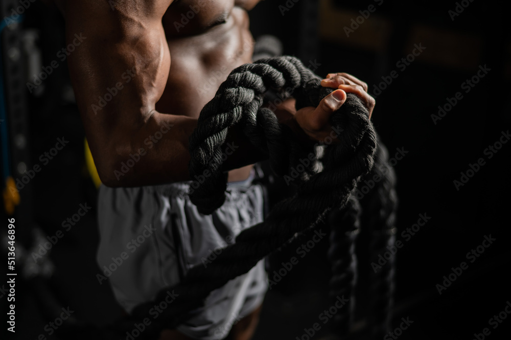 Muscular african american man posing with rope in gym. Stock Photo ...