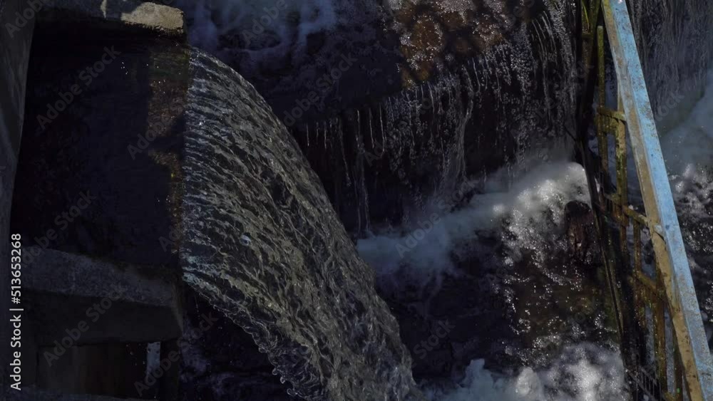 Dirty water flows into the river. Ecological catastrophy. Close up ...