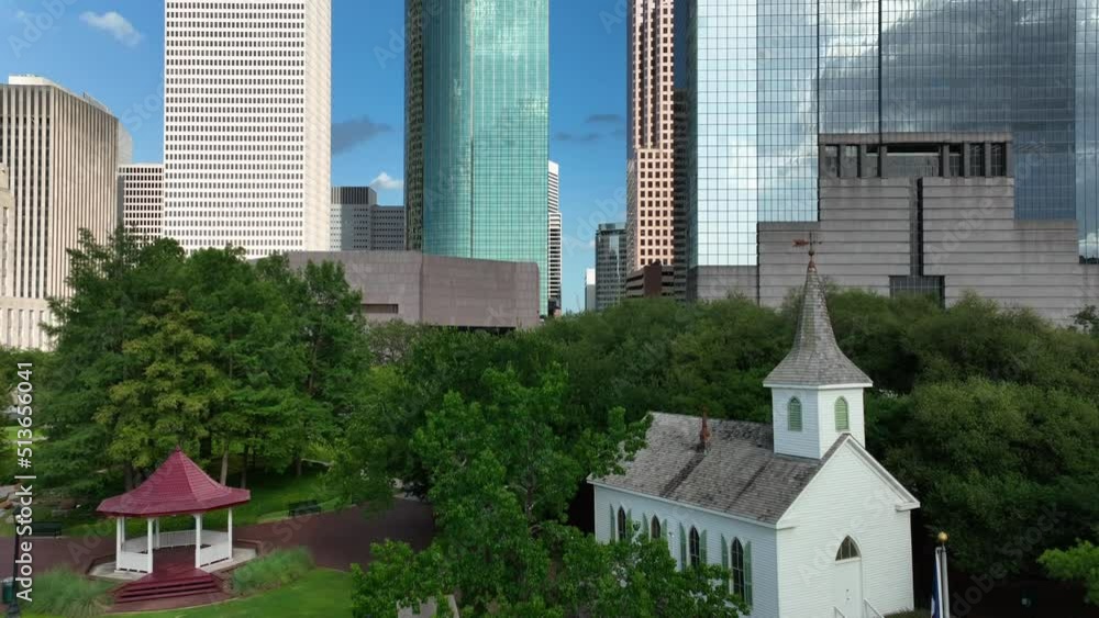 Sam Houston State Park and Texas flag. Rising aerial reveals downtown ...