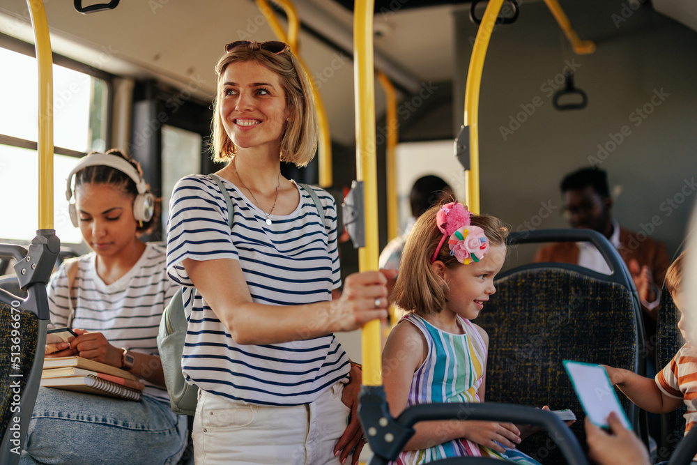 Young mom and daughter taking bus Stock Photo | Adobe Stock