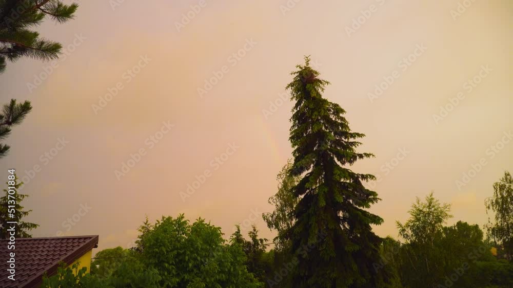 Blue yellow clouds after strong storm with fragments of rainbow on ...