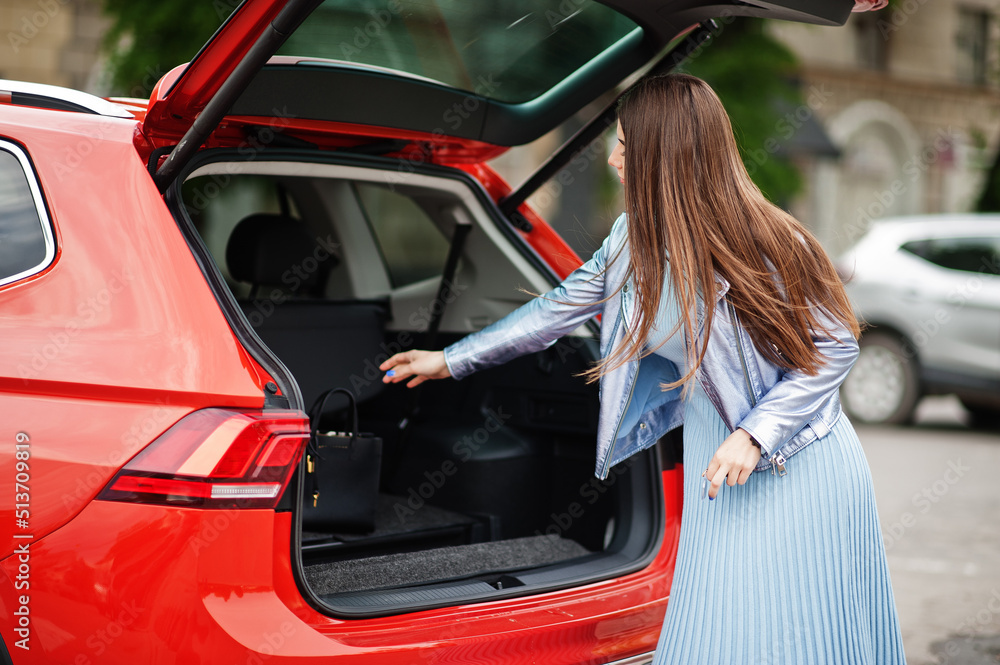 Outdoor photo of gorgeous woman posing near orange suv car with open ...