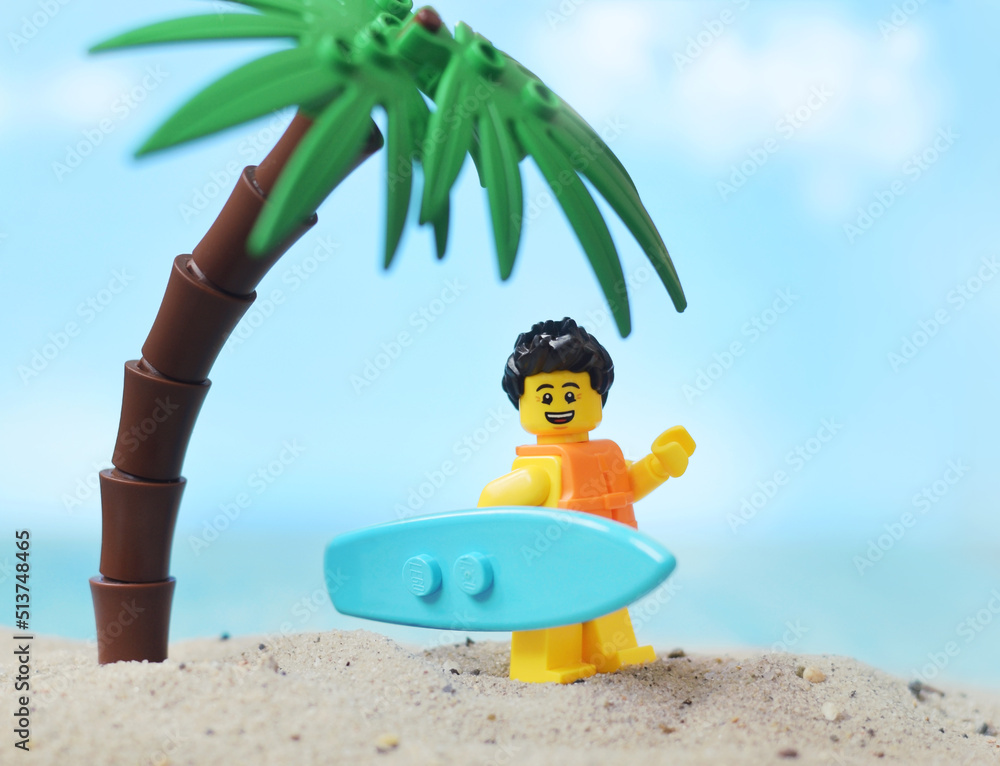 Lego minifigure surfer with surfboard on sandy beach. Editorial ...