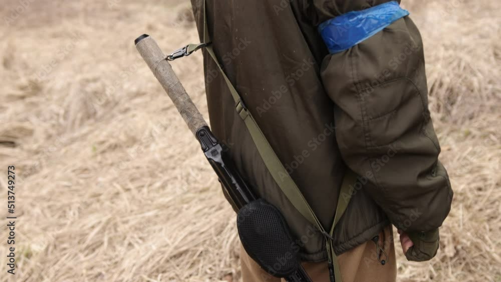 Man holds machine gun behind back. Secret agent with rifle. Male ...