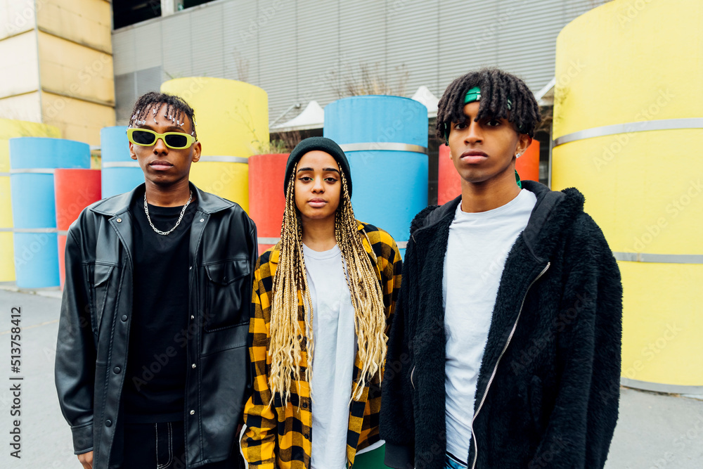 Multiracial friends standing in front of concrete pipes Stock Photo ...