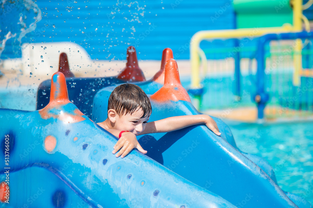 beautiful child playing in the pools of a water park in summer Stock ...