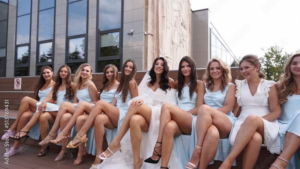 Attractive bride and bridesmaids switching crossing legs sitting on ... Attractive bride and bridesmaids switching crossing legs sitting on ...