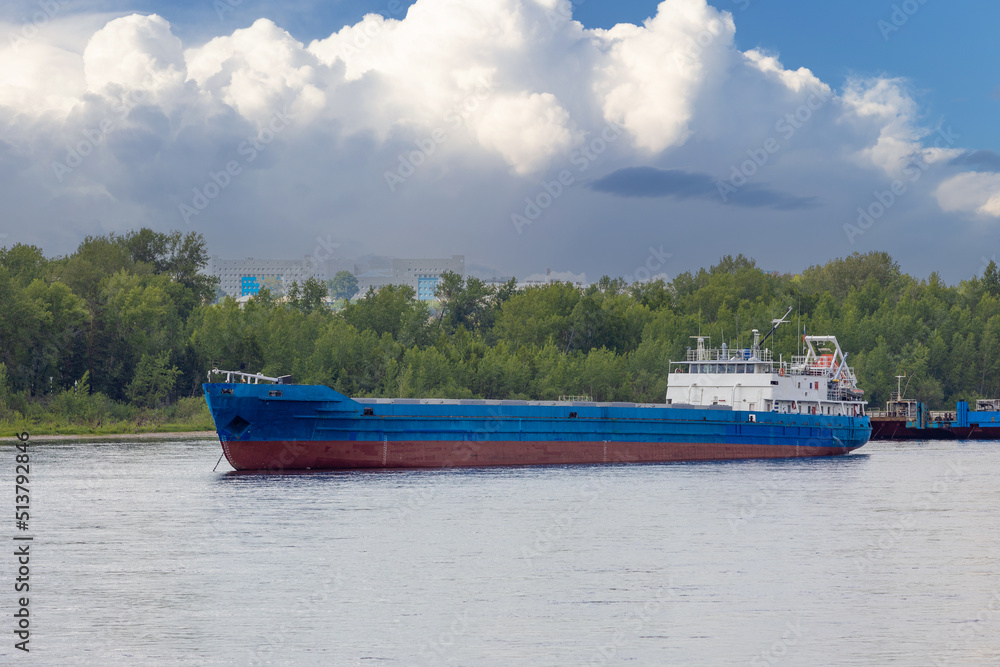 An empty cargo barge on the Yenisey river in Siberia, Russia. Barge is ...