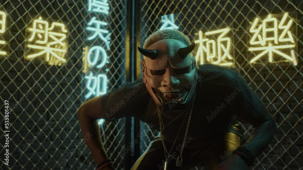 Low angle of young Black man with white hair in mask of demon dancing ...