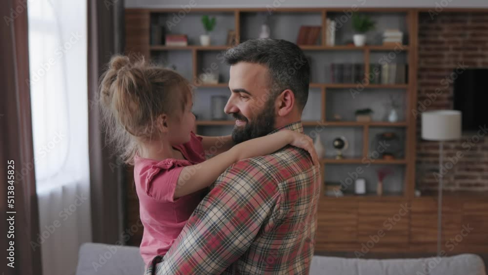 Happy cheerful family. Cute girl hugging her beloved dad around neck ...