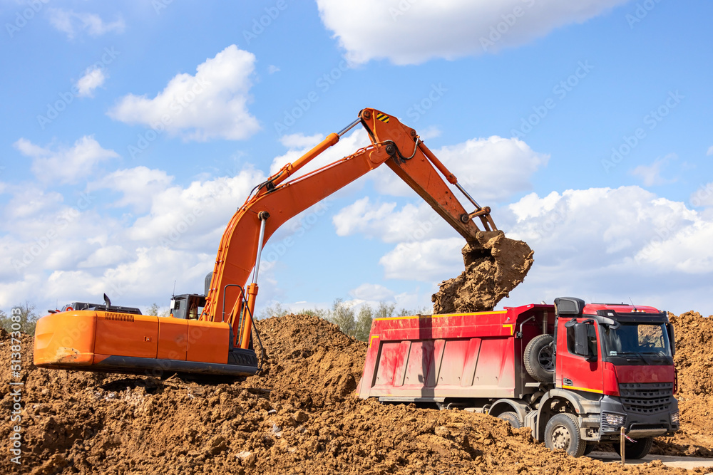 Excavator loading dump truck on the construction site Stock Photo ...