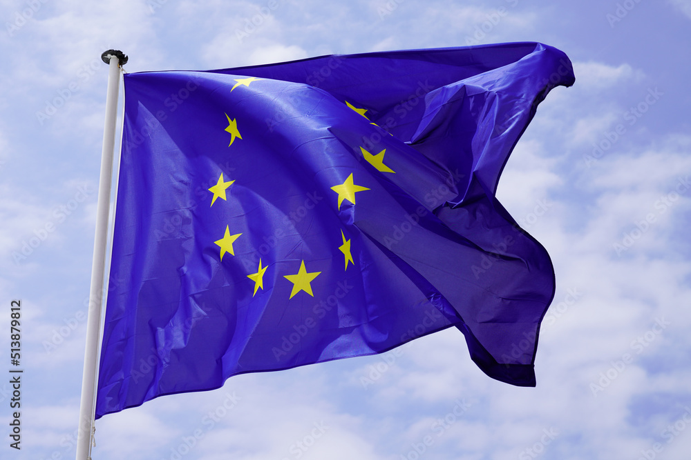 flag of European Union EU in cloud sky in mast with blue background and ...
