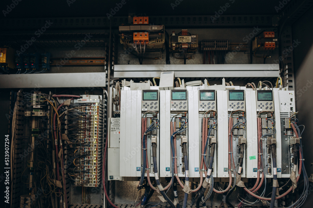 Electrical engineer using digital multi-meter measuring equipment to ...