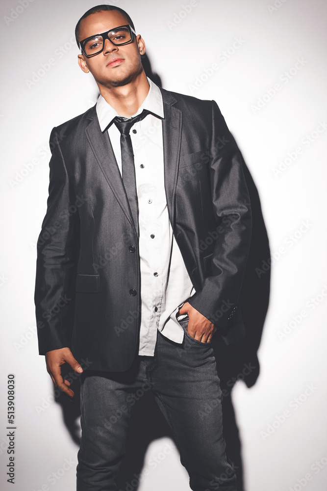 Man fashion model posing against a studio background Stock Photo ...