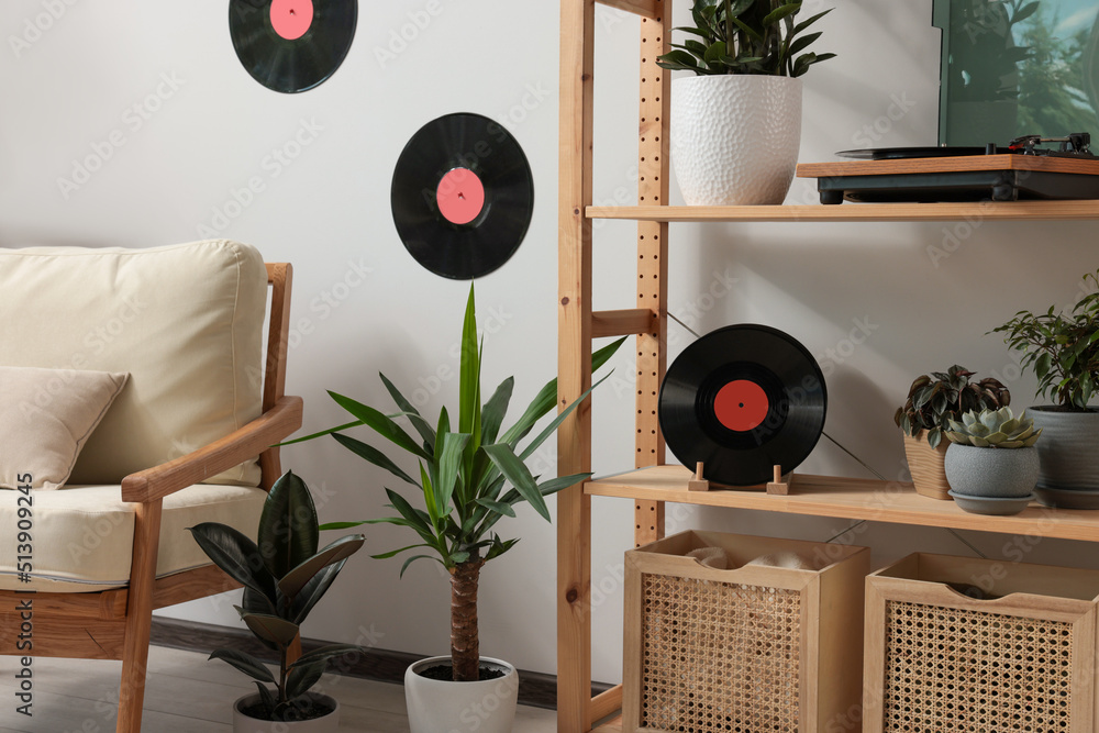 Living room interior with stylish turntable on wooden shelving unit and ...