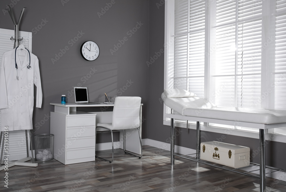 Modern medical office interior with doctor's workplace and examination ...