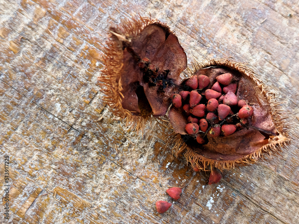 Brazilian Urucum Annatto Seeds on rustic background. Centered Open ...