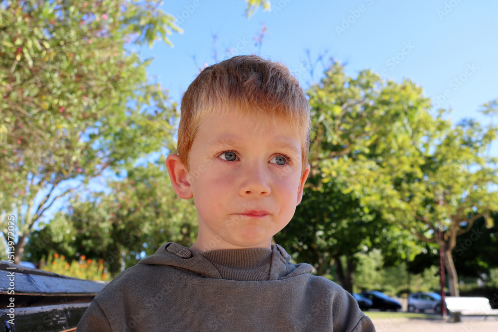 The blond boy bit his lower lip and looks attentively into the distance ...