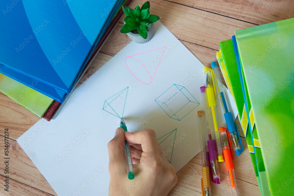 Foto de Human hand drawing geometry figures on white paper sheet. Top ...