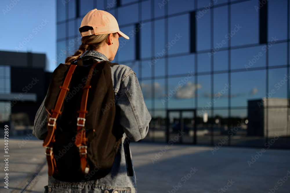 Travelling tourist with her backpack in walking down in downtown ...
