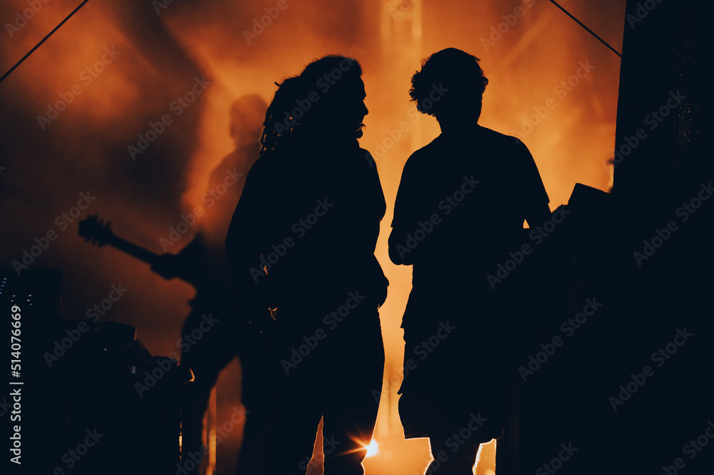 Silhouette of a stage workers standing on a stage with cables Stock ...