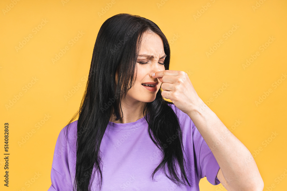Portrait of frustrated woman pinch nose with disgust on face due to bad ...