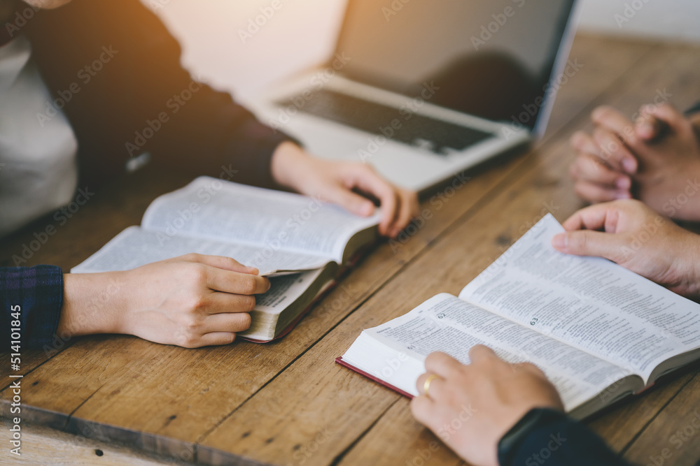Christian friends group reading, pray and study bible together in home ...