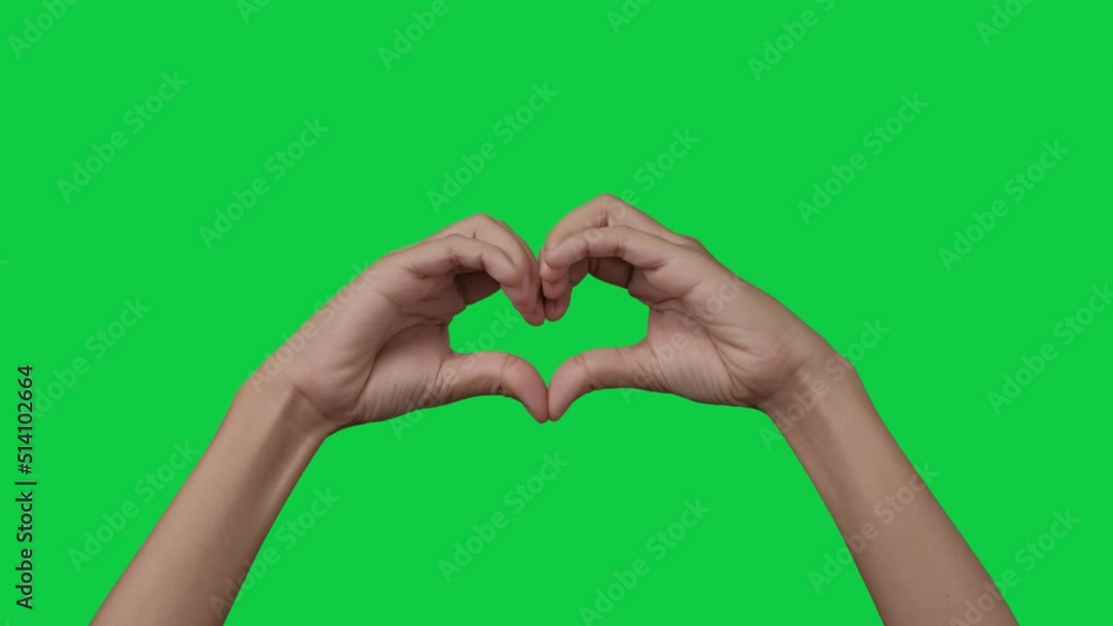 Woman hand making heart shape on chroma key green screen background ...