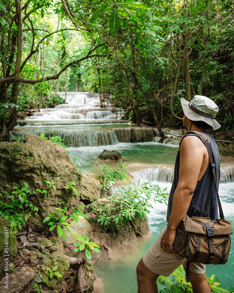 Foto de Thai guy Asian man backpacker men enjoying beautiful emerald waterfalls green forest ...