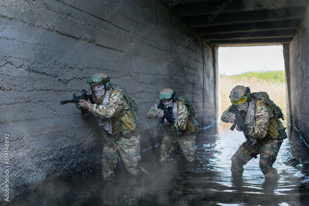 Three military mercenaries during special operation in underground ...