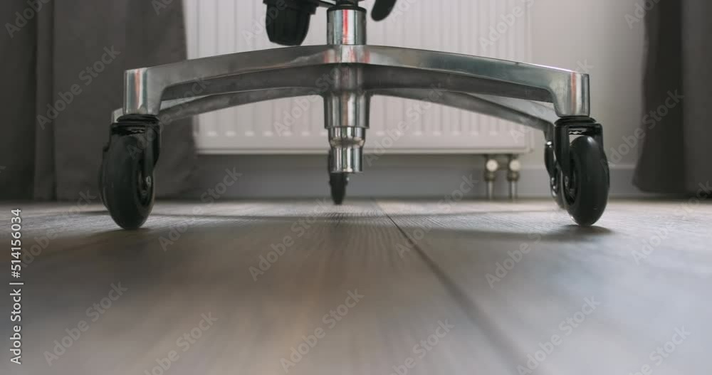 Office chair rolls over on camera. Close-up on the wheels of the chair ...