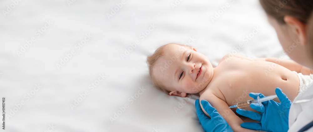 Doctor vaccinating baby in clinic. Little baby get an injection ...