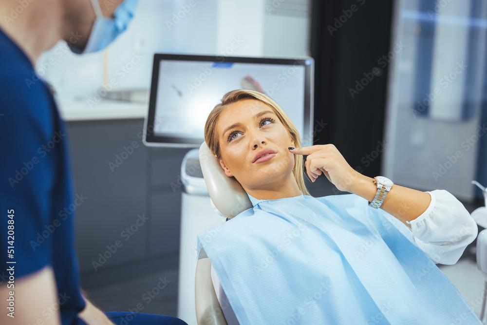 Dentist and patient in dentist office. Over the shoulder view of a ...