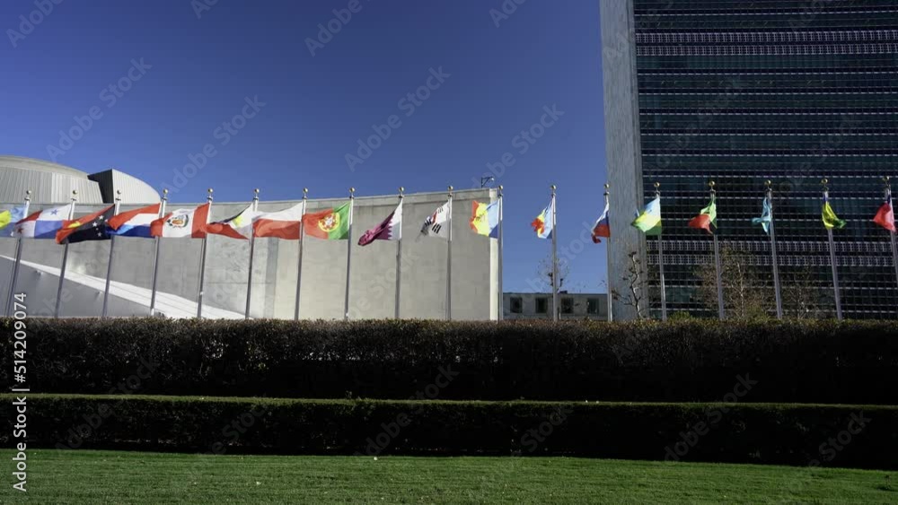 United Nations Building with flags from different countries flying in ...