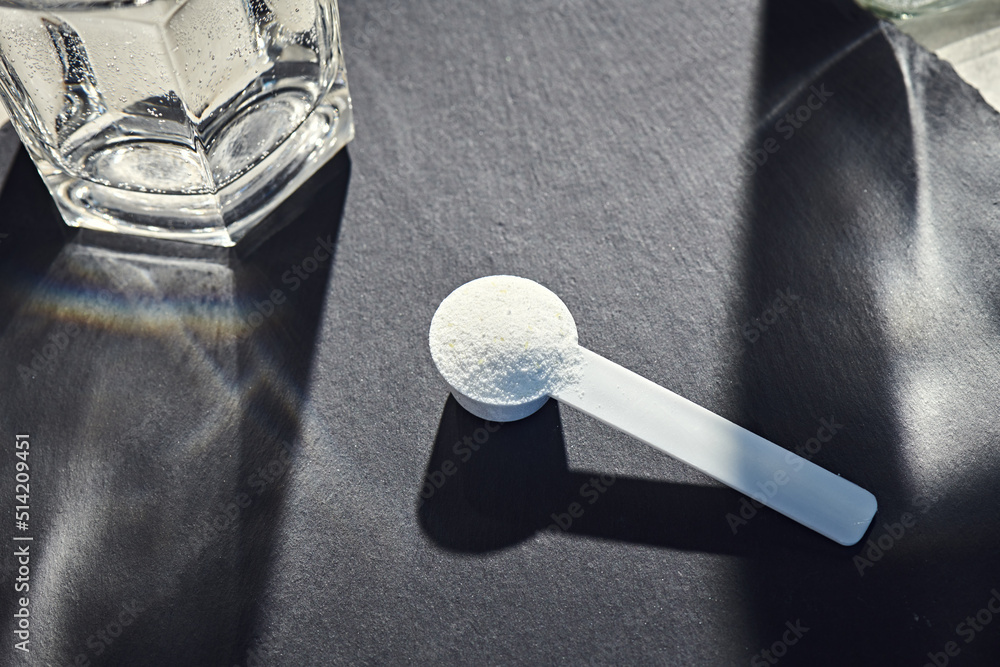 Sport food supplement powder with natural beige background and props ...