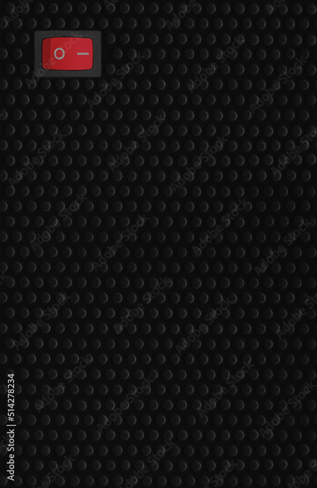 Red rectangle rocker power switch in on position, black abstract dot ...