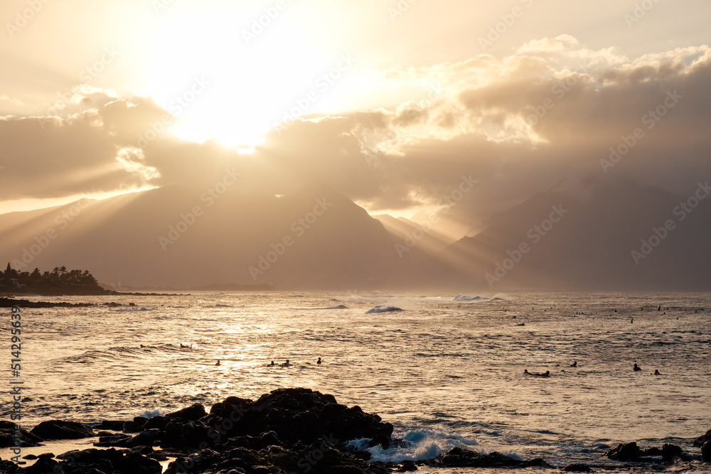 swimmers and surfers in the water during a spectacular sunset Stock ...
