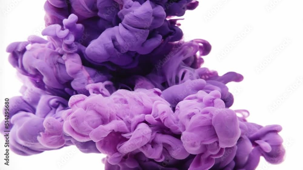 Drops of purple ink in water. Purple watercolor ink in water on a white ...