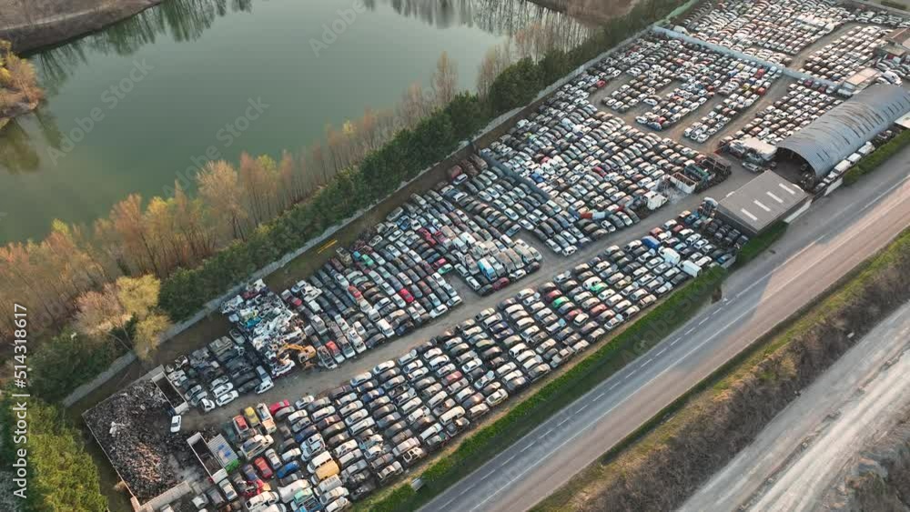 Aerial view of big parking lot of junkyard with rows of discarded ...