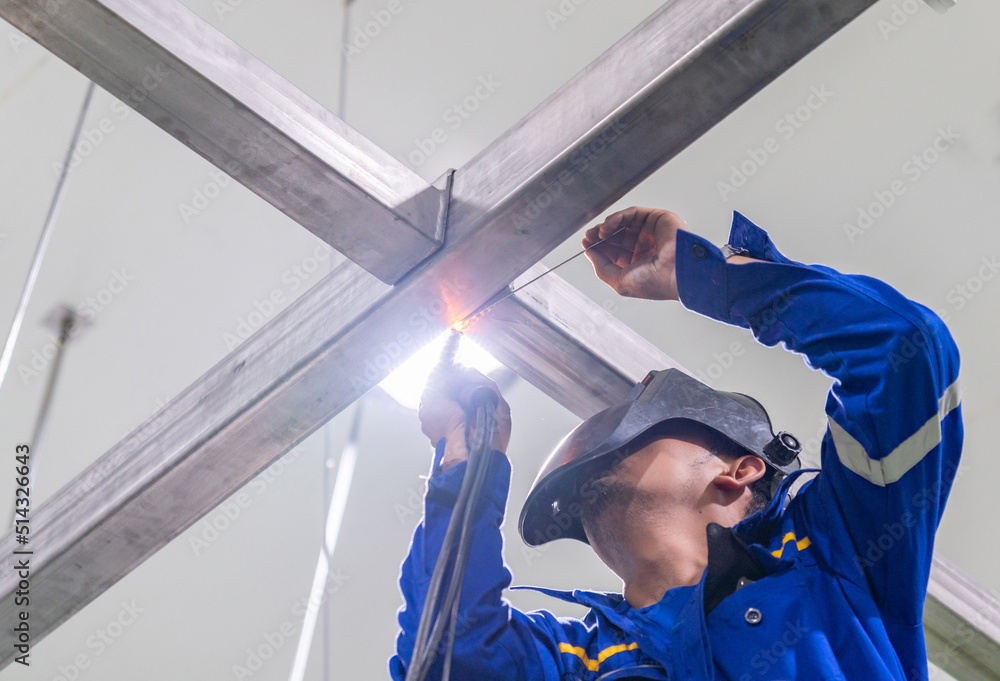 Welder welding stainless steel truss structure assembly on factory and ...