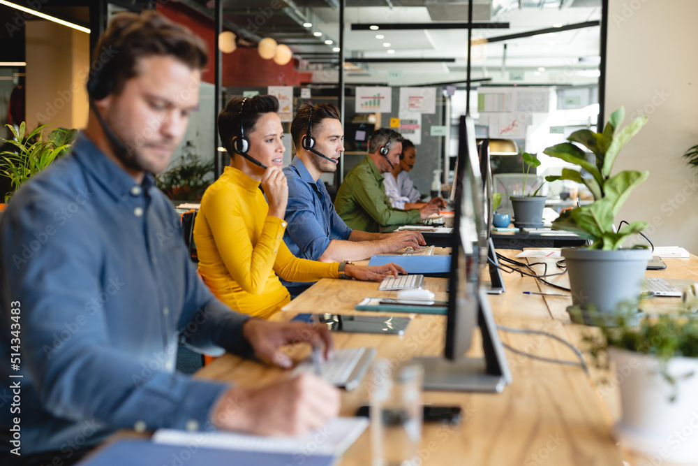 Multiracial male and female customer service executives working in ...