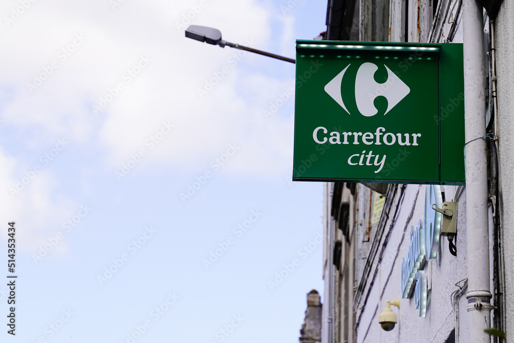 carrefour city text brand and logo sign on facade town store entrance ...