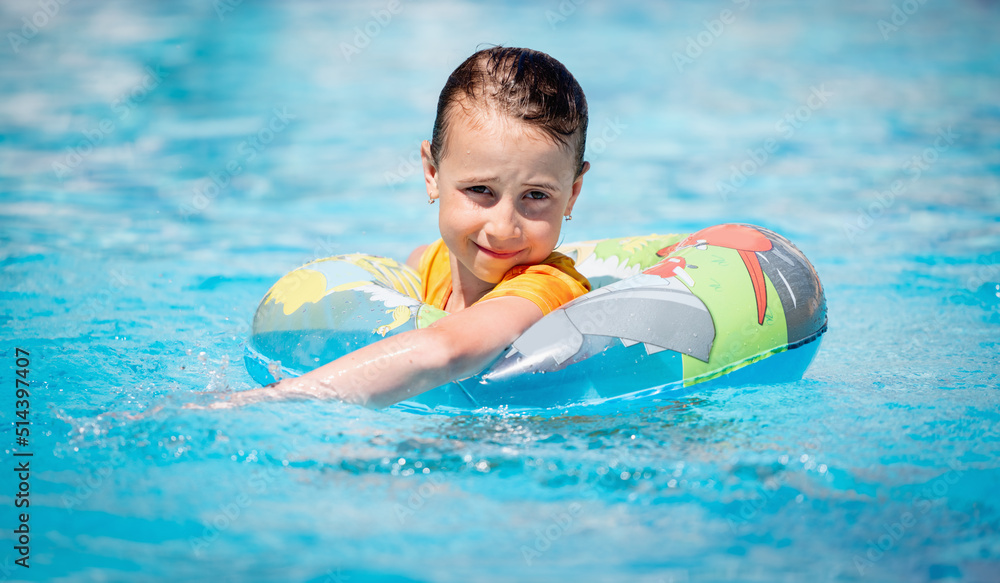 Portrait of happy kid have fun in the pool. Joyful child girl on ...