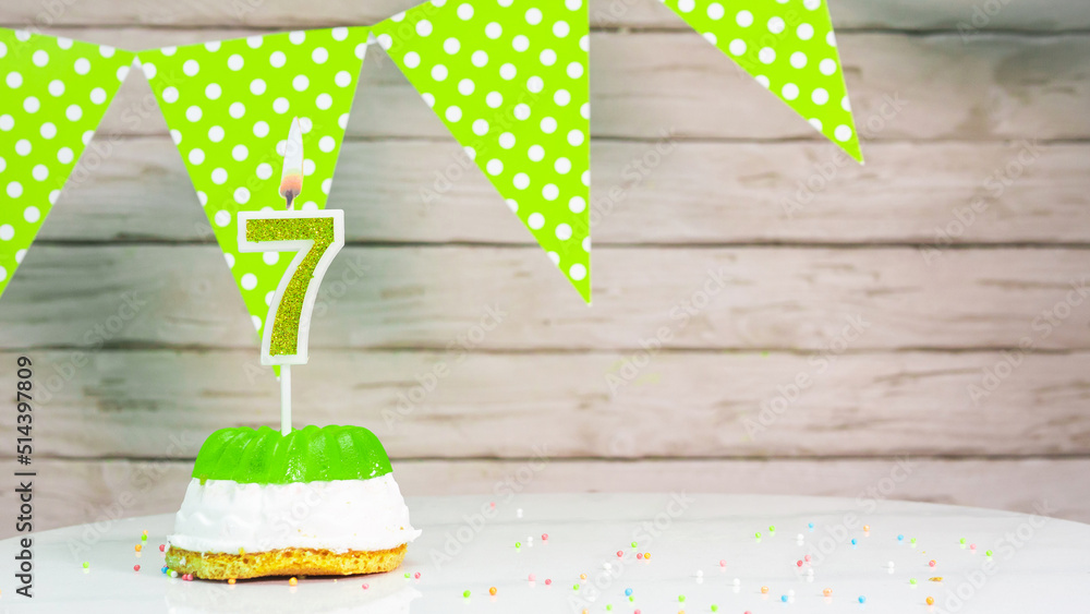 Beautiful festive background with the number 7 with a cake and lit ...