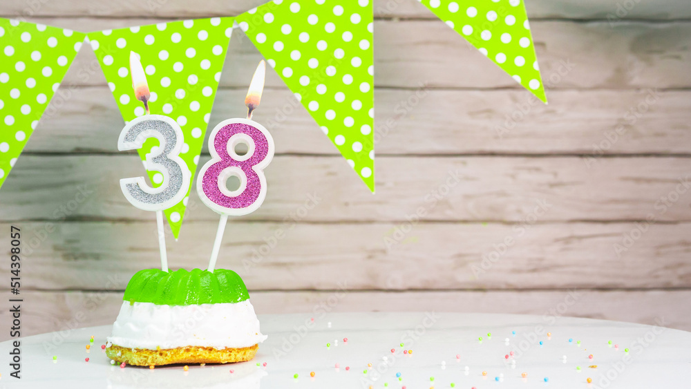 Beautiful festive background with the number 38 with a cake and lit ...