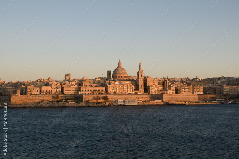 Sunlight from the setting sun covering the fortified capital city of ...