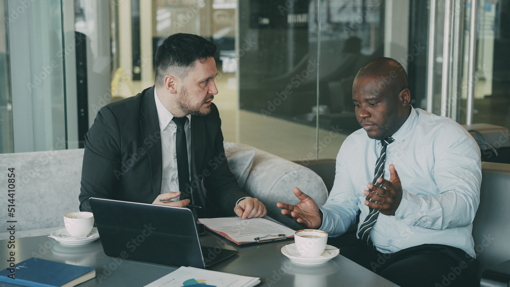 Angry Caucasian ceo in black business suit, white criticizes severely ...