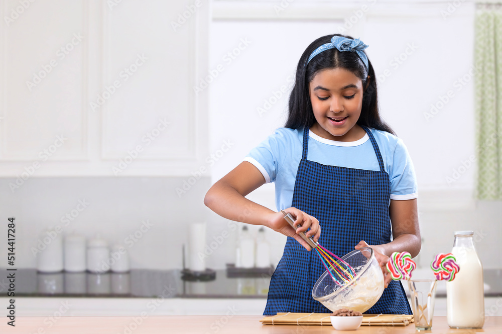 Girl baking cakes in the kitchen Stock Photo | Adobe Stock