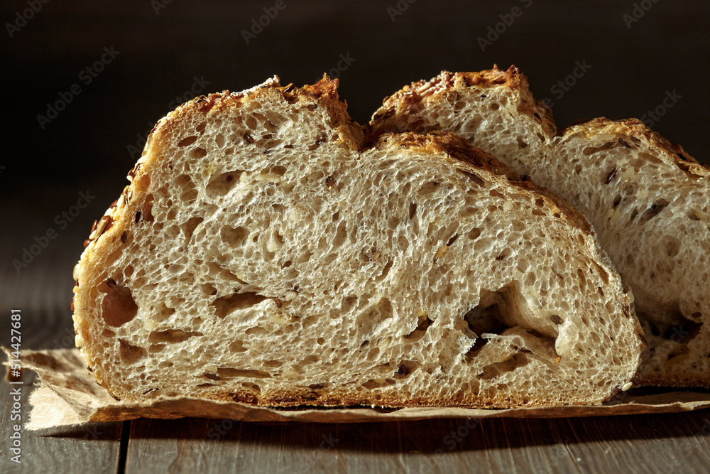 Bread, traditional sourdough bread cut into slices on a rustic wooden ...