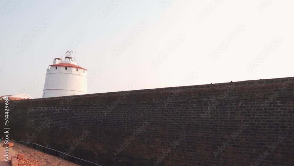 Vidéo Stock Wide angle shot of ancient lighthouse and fort wall of the ...